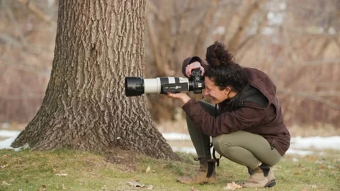 Woman wildlife photographer is filming n... | Stock Video | Pond5