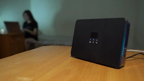 Woman is working at home a modem router,... | Stock Video | Pond5