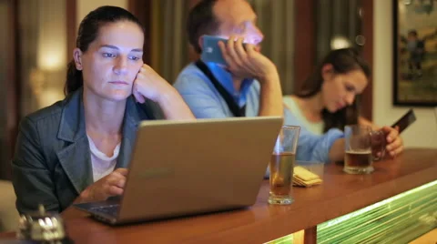 Woman working on laptop in pub and drink... | Stock Video | Pond5