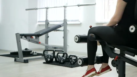 Woman working legs her body at the gym | Stock Video | Pond5