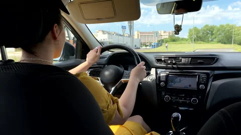 woman in yellow dress driving car | Stock Video | Pond5
