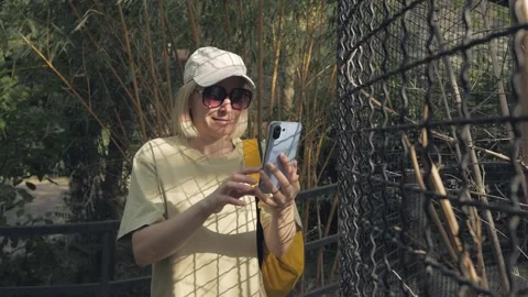 A woman at the zoo, standing next to the... | Stock Video | Pond5