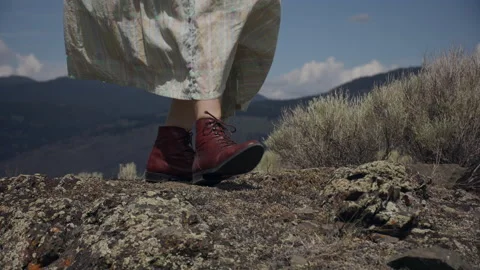 Woman's feet in boots dancing on rock ou... | Stock Video | Pond5