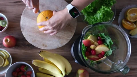Womans hand cut and put fruits and berri... | Stock Video | Pond5