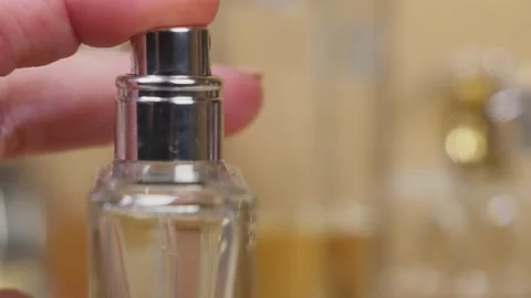 Woman's hand finger sprays perfume on ba... | Stock Video | Pond5