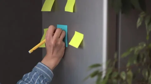 woman's hand makes a note on a sticker o... | Stock Video | Pond5