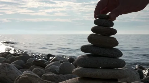 Woman's hand making pyramid of stones fo... | Stock Video | Pond5