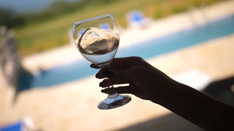 Woman's Hand Mixing Wine In A Glass Near... | Stock Video | Pond5