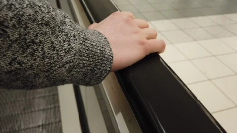 Woman's hand on moving walkway railing | Stock Video | Pond5
