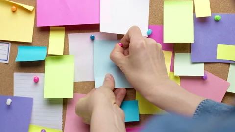 A woman's hand pins a blank paper note o... | Stock Video | Pond5