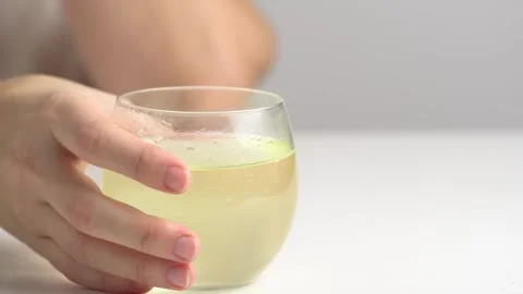 A woman's hand takes a glass with a diss... | Stock Video | Pond5