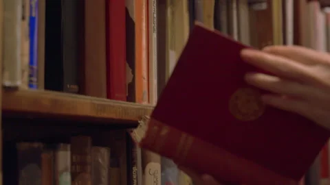 Woman's hand taking a book from a booksh... | Stock Video | Pond5