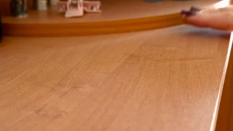 A woman's hand wipes dust on the table | Stock Video | Pond5