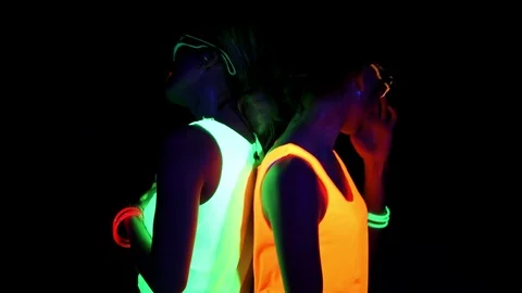 Women dancing in UV blacklight, glow par... | Stock Video | Pond5