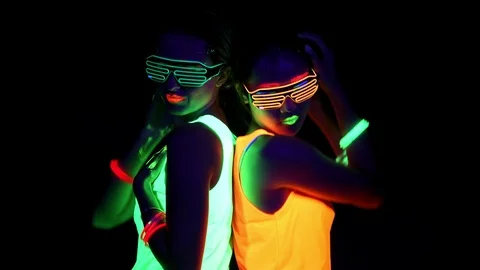 Women dancing in UV blacklight, glow par... | Stock Video | Pond5