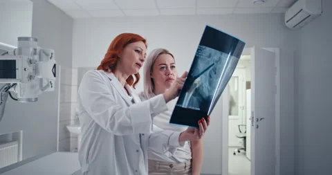 Women discussing X ray scan in lab | Stock Video | Pond5