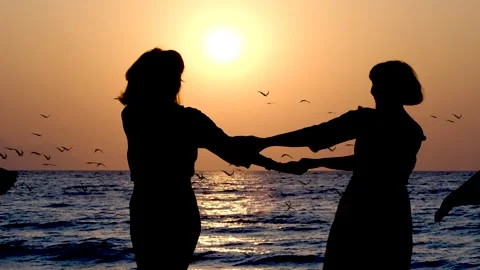 Two Best Friends Holding Hands In The Sunset