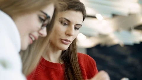 Women look pictures on phone or tablet. ... | Stock Video | Pond5