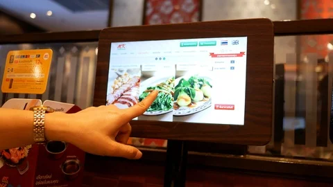 Women select menu of MK Suki hot pot | Stock Video | Pond5