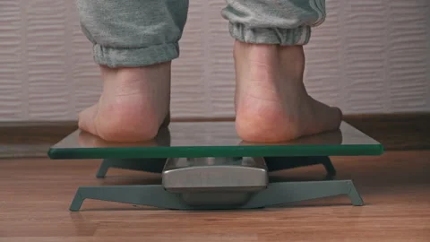 Women's Feet Stand on the Scales and Che... | Stock Video | Pond5