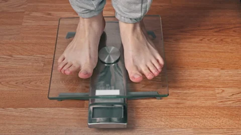 Women's Feet Stand on the Scales and Che... | Stock Video | Pond5