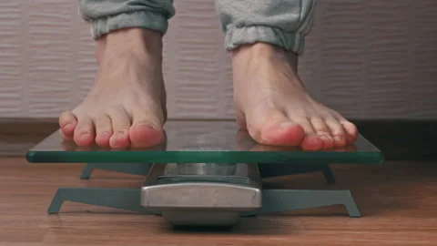 Women's Feet Stand on the Scales and Che... | Stock Video | Pond5