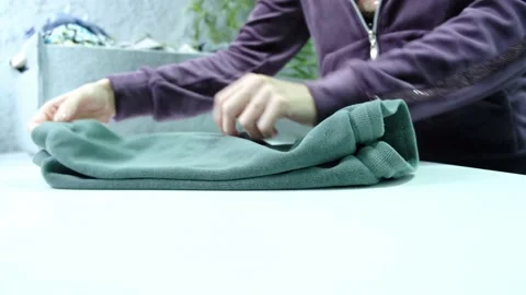 Women's hands fold clothes in a laundry ... | Stock Video | Pond5