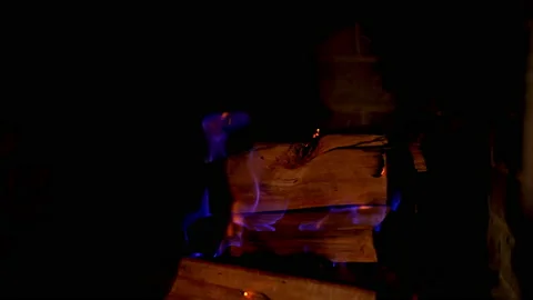 Wood in blue fire flame on dark backgrou... | Stock Video | Pond5