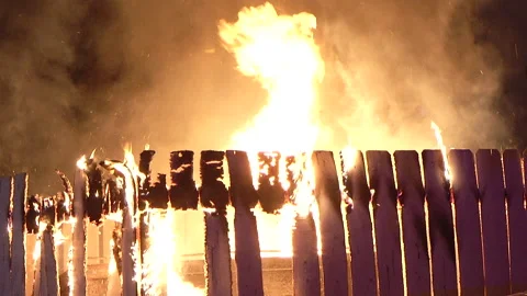 Wood fence on fire with flames at night | Stock Video | Pond5
