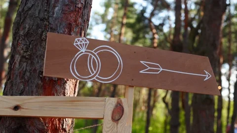 Wooden arrow sign with wedding rings on ... | Stock Video | Pond5