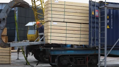 A wooden beam is pushed into the train, ... | Stock Video | Pond5