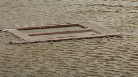 A Wooden Door Floating on the Surface of... | Stock Video | Pond5