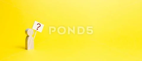 Wooden human figurine with a question mark. Minimalism. Asking a ...