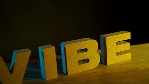 Wooden VIBE letters in black background | Stock Video | Pond5