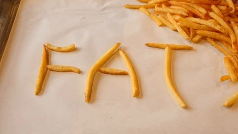 Word Fat layout of french fries by a man... | Stock Video | Pond5