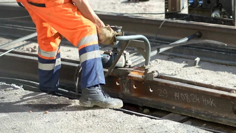 Worker grinding rail track after welding... | Stock Video | Pond5