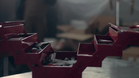 worker in his garage with a red tool sto... | Stock Video | Pond5