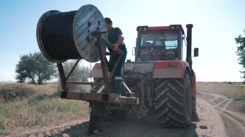 Worker lay the cable in the ground with ... | Stock Video | Pond5