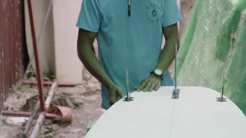 A worker making a surf board inside a st... | Stock Video | Pond5