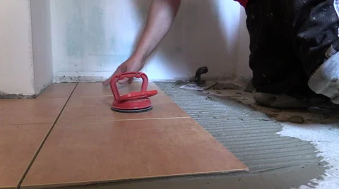 worker man place floor tiles. Home renov... | Stock Video | Pond5