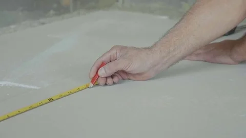 Worker marking a drywall sheet for insta... | Stock Video | Pond5