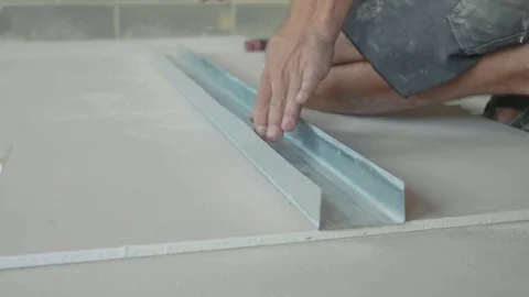 Worker marking a drywall sheet for insta... | Stock Video | Pond5