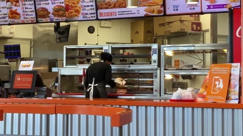 A worker at a Popeyes restaurant fast fo... | Stock Video | Pond5