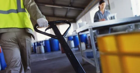 Worker pulling a trolley with crate in o... | Stock Video | Pond5