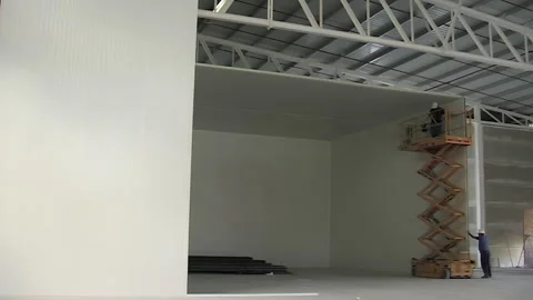 Workers and scaffolds inside a warehouse... | Stock Video | Pond5
