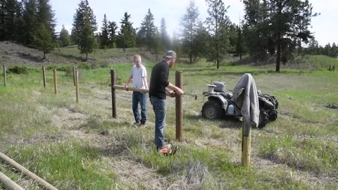 Workers building trail fence, barb wire | Stock Video | Pond5