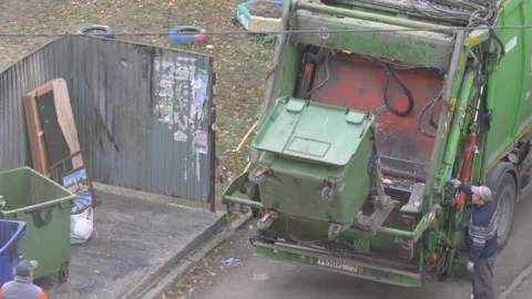 Workers empty the garbage cans and load ... | Stock Video | Pond5