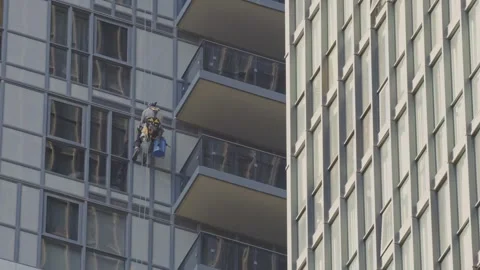 Workman Hanging Steadily On The Exterior... | Stock Video | Pond5