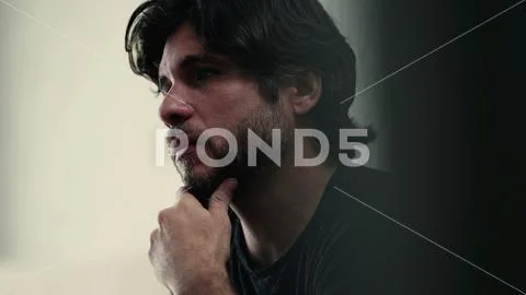 Worried young man mentally stuck in stress and anxiety. Preoccupied ...