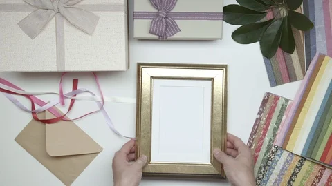 Wrapping photo frame as gift. Speed up. ... | Stock Video | Pond5